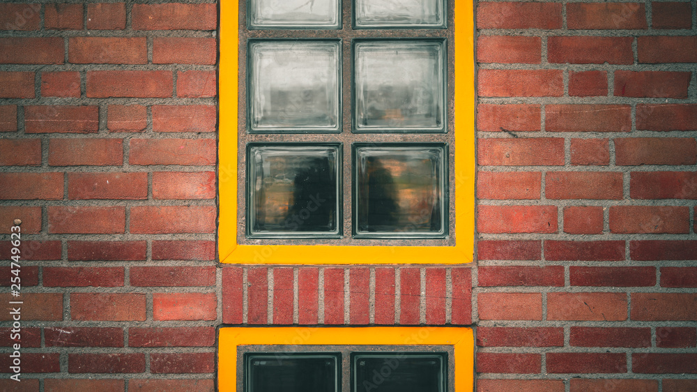 Brick wall with a bright yellow window frame Stock Photo | Adobe Stock