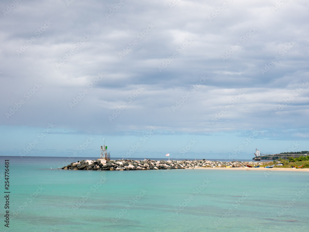 Small lighthouse and Puerto Rican flag on the end of a peninsula on the ...