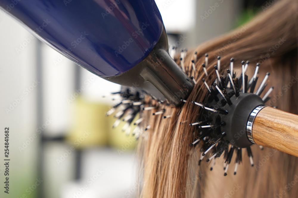Brushing of long female hair in salon, closeup Stock Photo | Adobe Stock