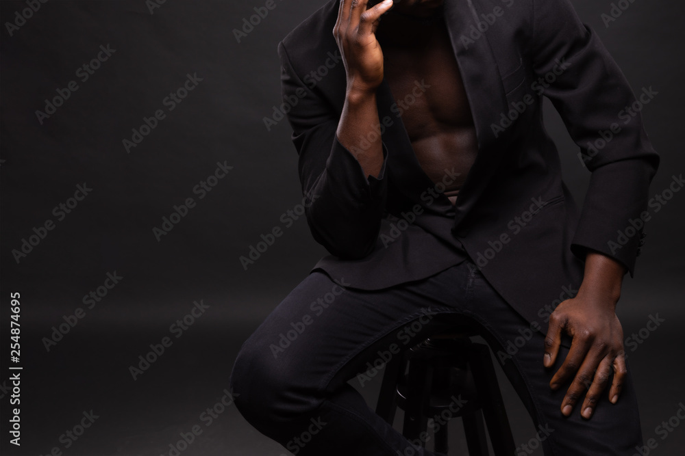 Beautiful and muscular black man in dark background. Stock Photo ...