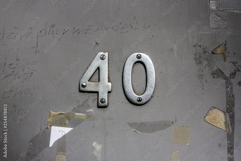 House number forty an a run down dilapidated door covered with ...