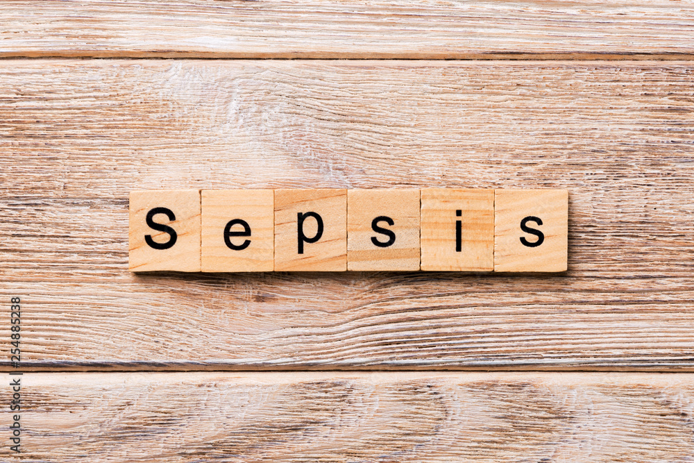 Sepsis word written on wood block. Sepsis text on wooden table for your ...