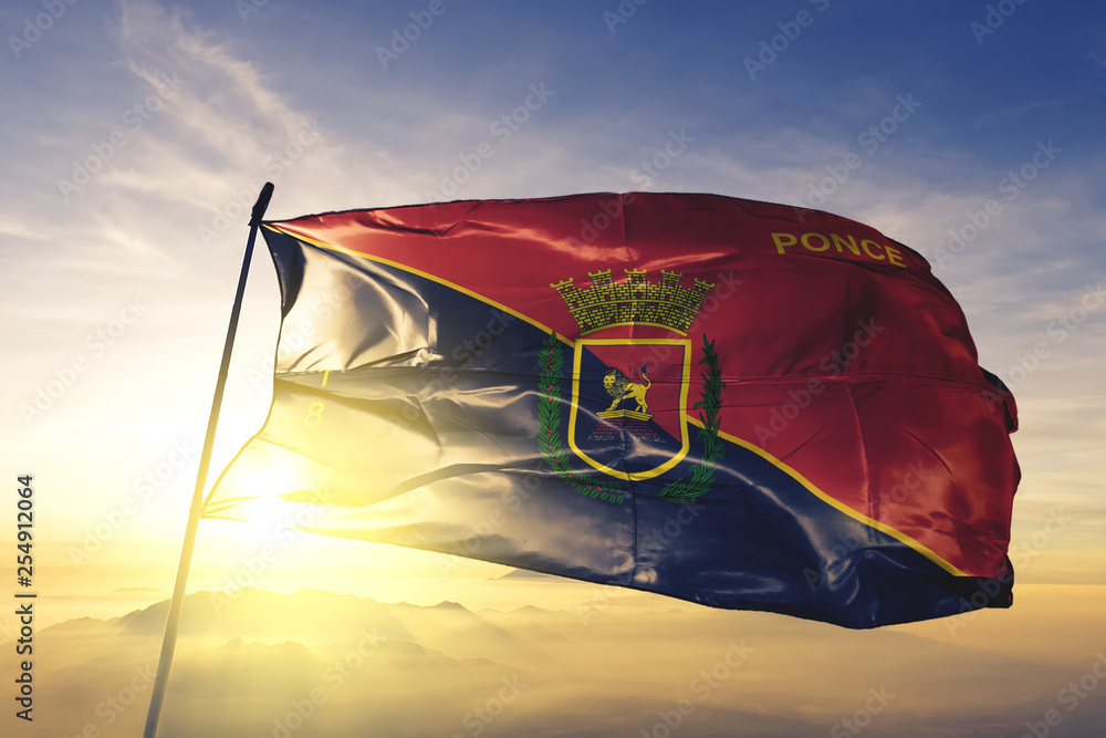 Ponce municipality of Puerto Rico flag waving on the top sunrise mist ...