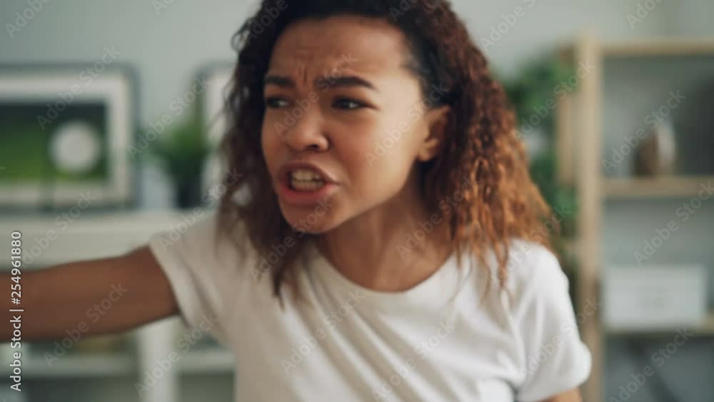 Portrait of irritated African American teenager in white T-shirt ...