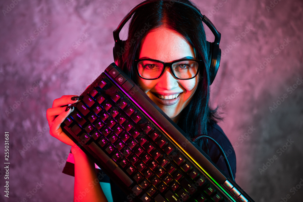 Portrait of the Beautiful Young Pro Gamer Girl standing with a gaming ...