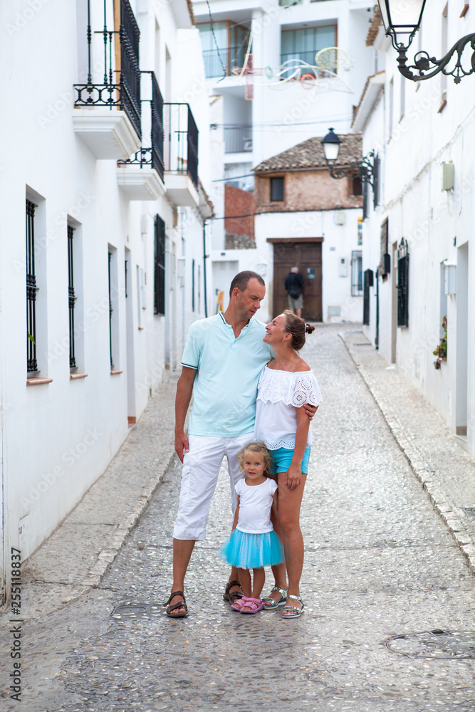 Family vacation in Europe. parents and daughter at street of typical ...