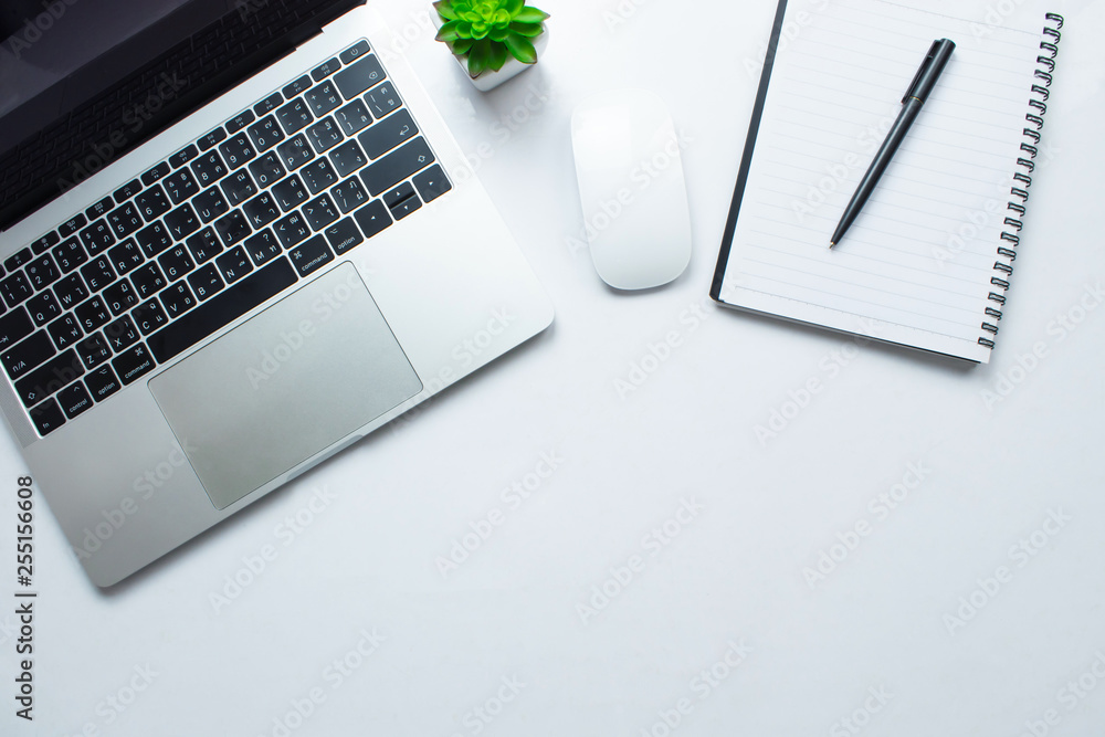 Top view of a modern white desk with a laptop table and other devices ...