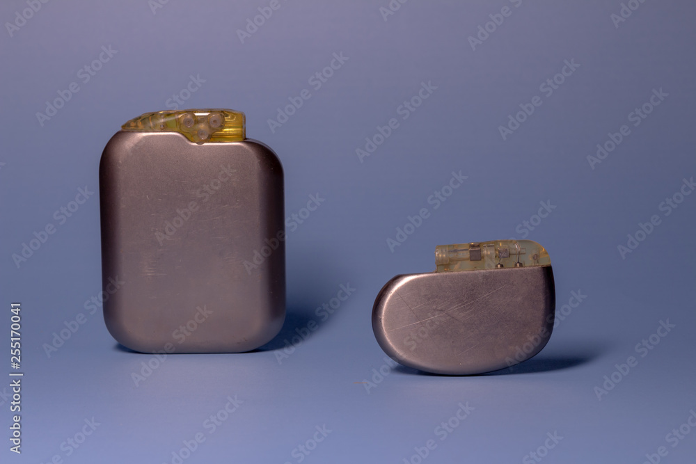 Two old pacemaker collection on a neutral background. Implantable ...