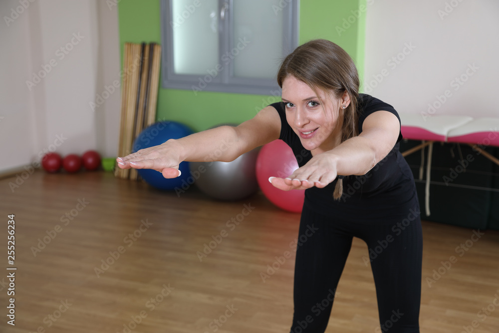Fitness Trainer Practicing In The Gym, Bending Forward With Her Arms ...