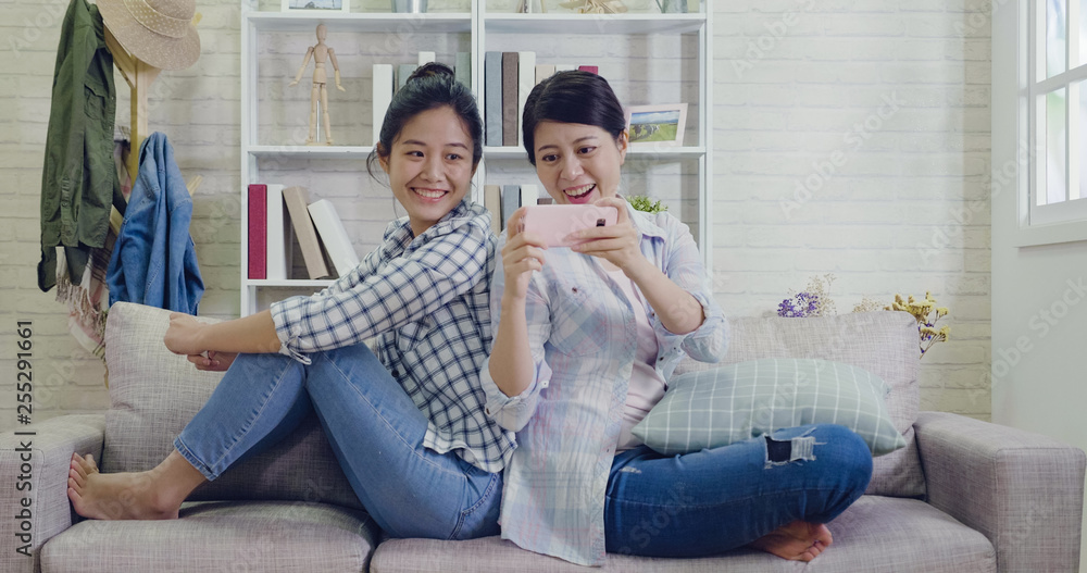 friendship technology at home concept. female roommates showing ...
