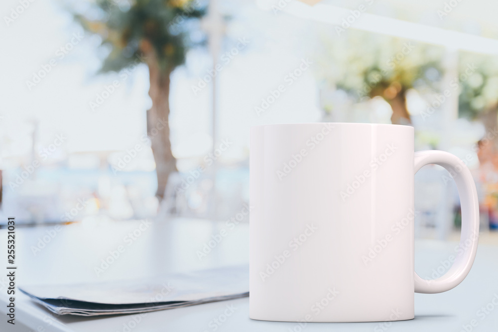 White mug on a table top in a restaurant. Perfect for businesses ...