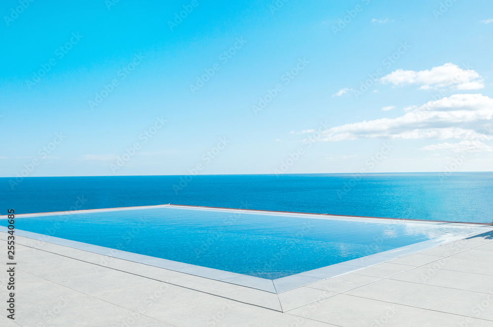 Luxury swimming pool in front of the sea. Swimming pool with beautiful ...