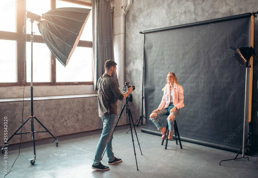 positive girl laughing at the camera at photo studio, side view shot ...