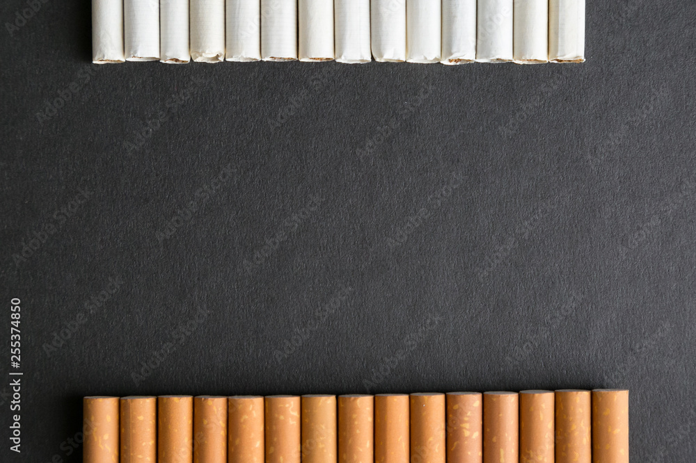 Place for text among cigarettes and tobacco, black background. Free ...