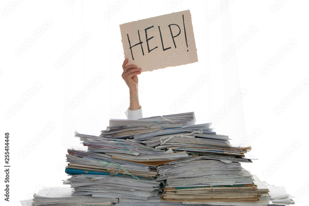 Person under a pile of papers with a hand holding a sign of help ...