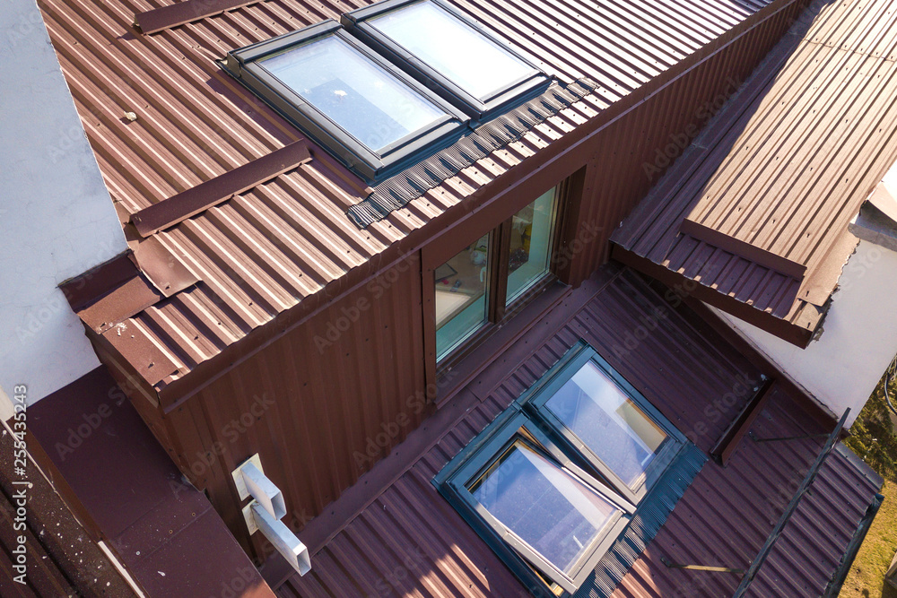 Aerial view of annex room exterior with plastic attic windows, roof and ...