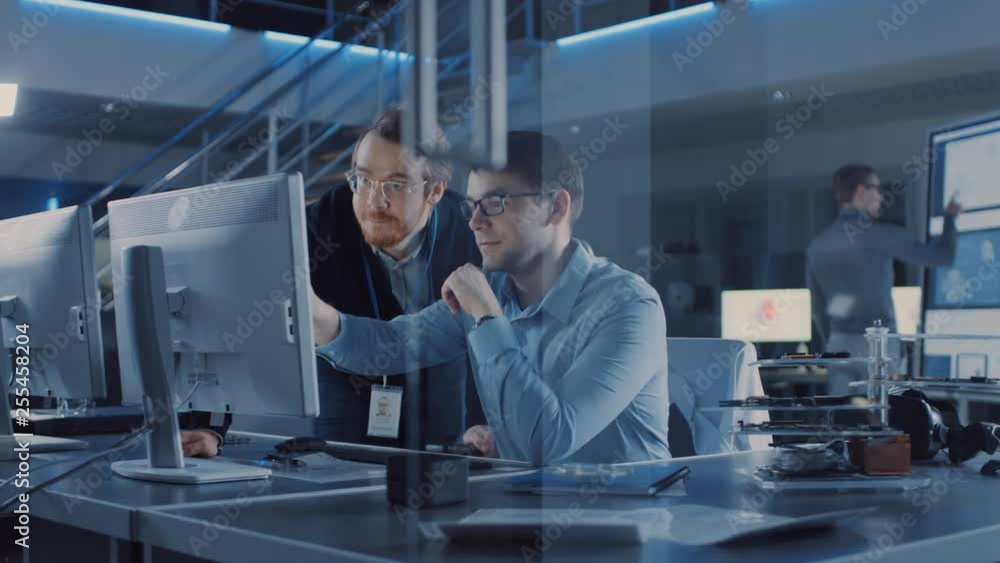 Electronics Development Engineer Uses Personal Computer Talks with ...