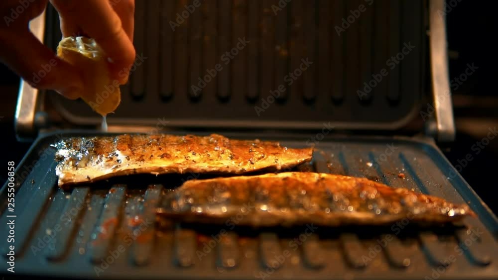 Chef Pouring Grilled Fish With Lemon juice.Pouring Lemon Juice Over The ...