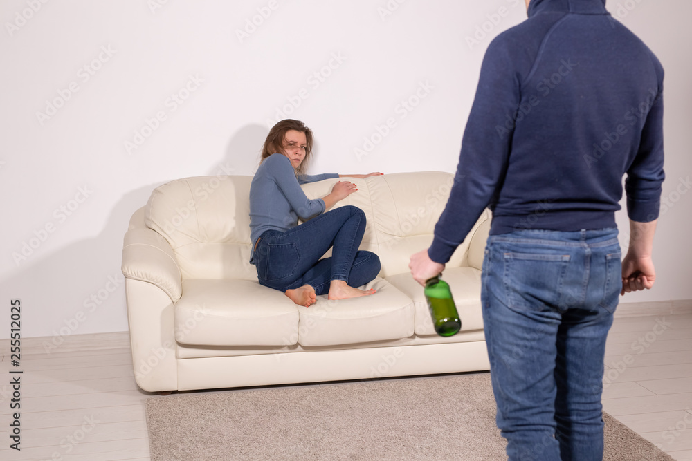 alcoholic, domestic violence and abuse concept - man gets drunk at home ...