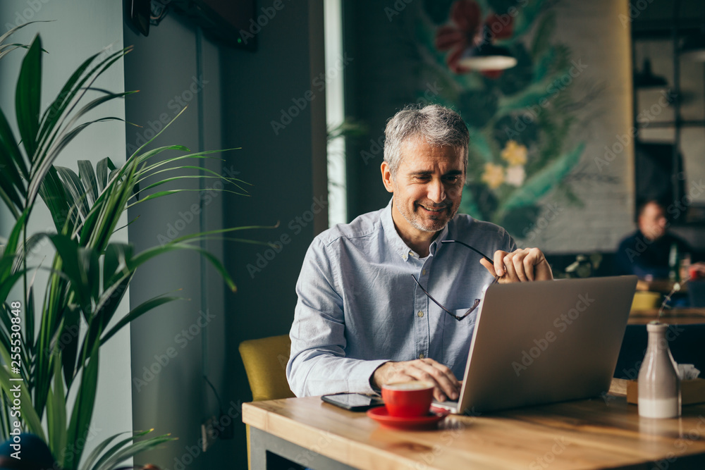 man sitting table in cafe bar and using laptop. drinking coffee. Stock ...