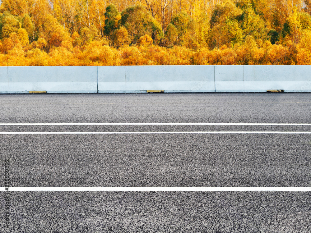 Road autumn background. Barrier, designed to prevent the exit of the ...