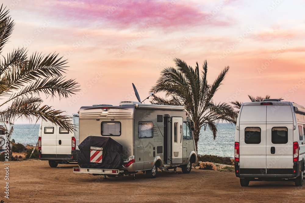 Motorhome making wild camp on the beach at a beautiful sunset or ...