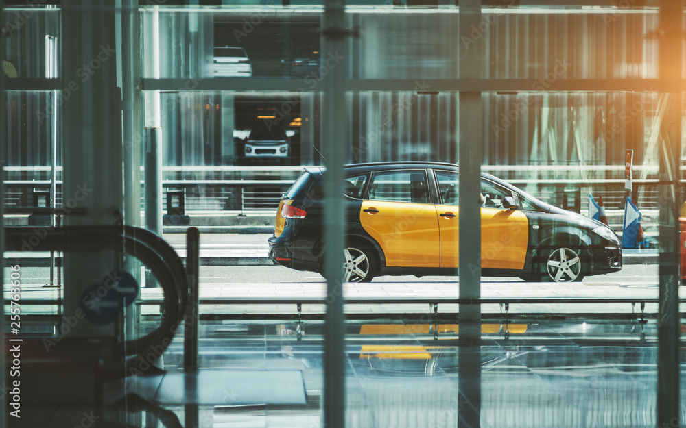 A modern yellow taxi car passing by, view through the window of a ...