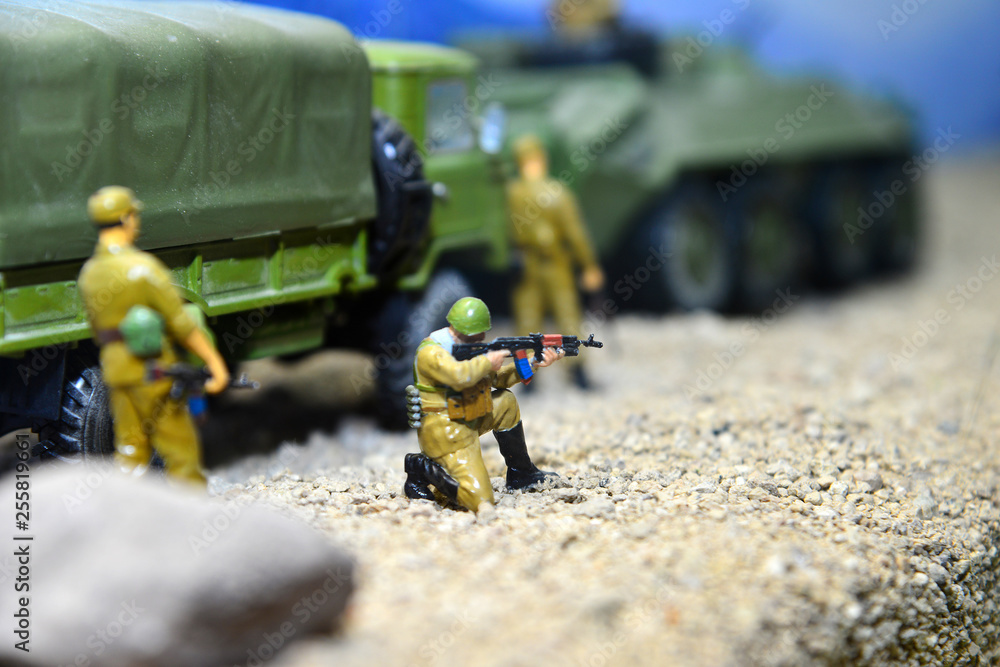 Fighting in a toy form, soldiers and military equipment, a war ...