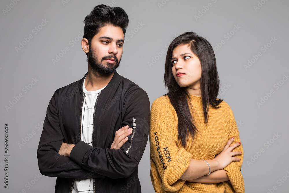 Beautiful indian couple standing apart from each other while being in a ...