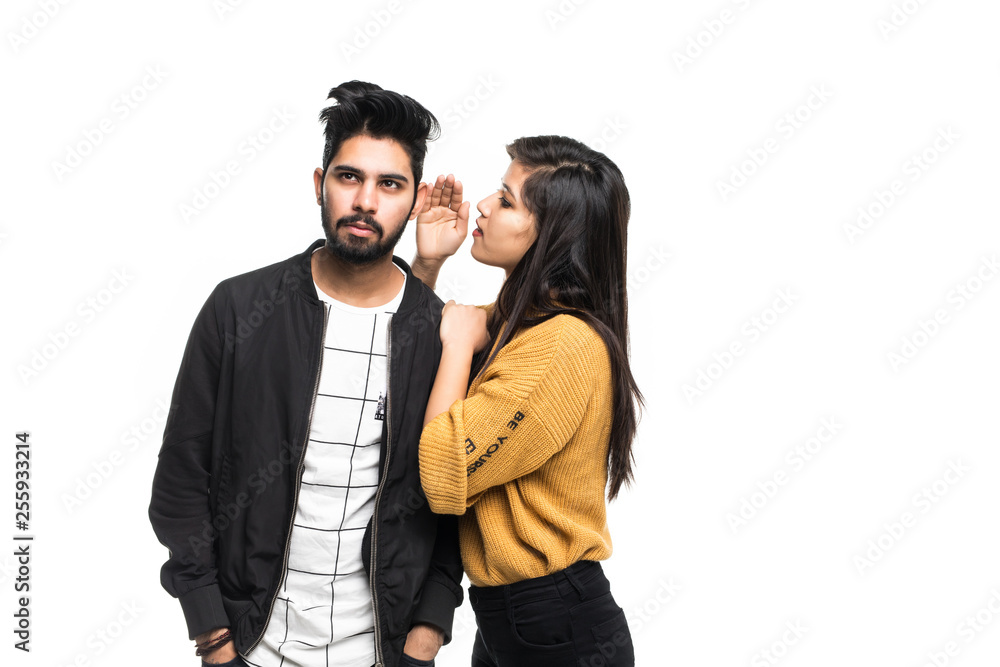 Beautiful indian woman whispering to boyfriends ear isolated on white ...
