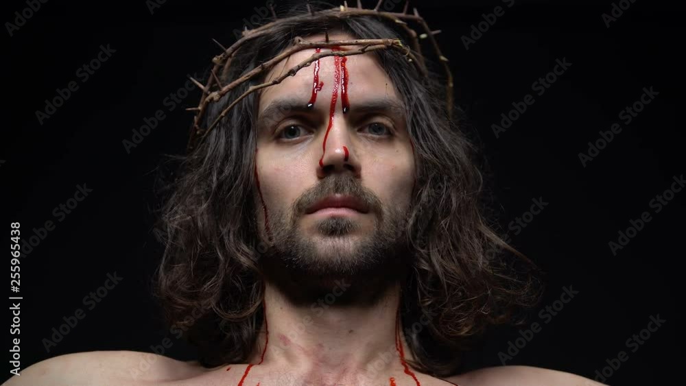 Crucified Jesus with crown of thorns bleeding, redeeming people sins ...