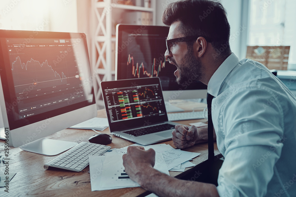 Stock falling. Frustrated young businessman in formalwear keeping mouth ...
