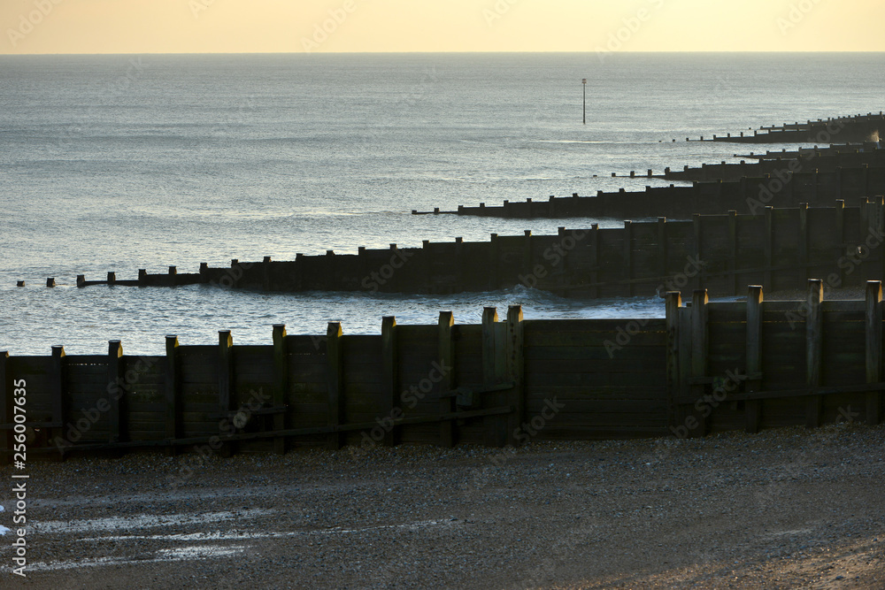 Wooden groynes on a shingle beach to prevent coastal erosion Stock ...