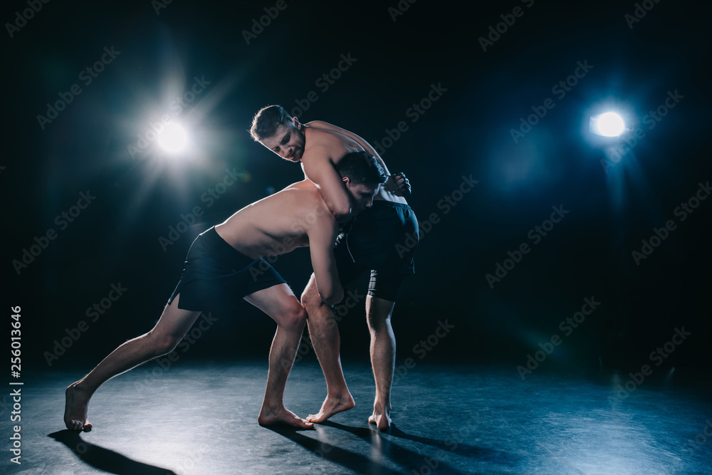 mma fighter doing chokehold and joint lock to another sportsman in ...