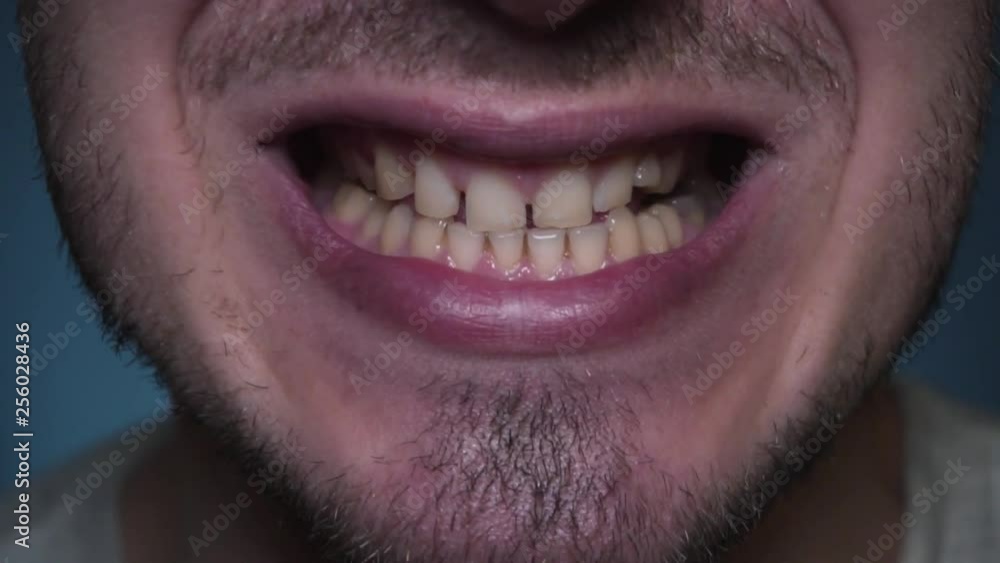 A man opens his mouth wide in front of the camera, shows emotions ...