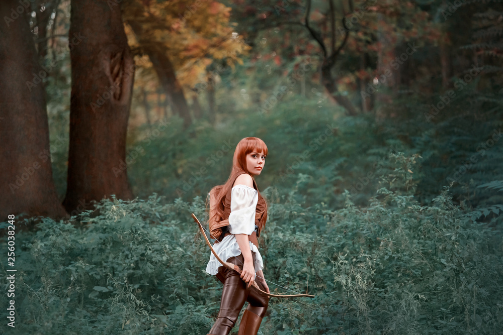 image of a forest hunter, an attractive girl with long red hair in a ...