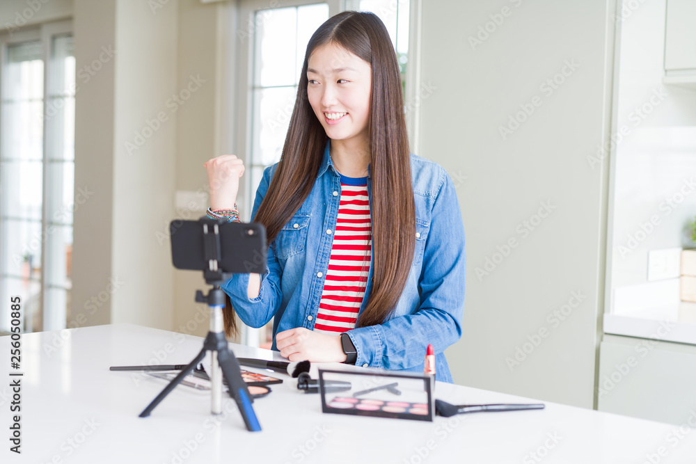 Beautiful Asian influencer woman recording make up tutorial using ...
