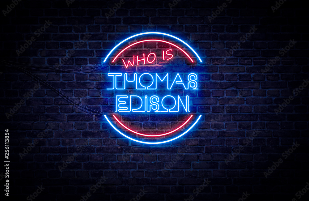 A red and blue neon sign on a brick wall that reads: Who is Thomas ...