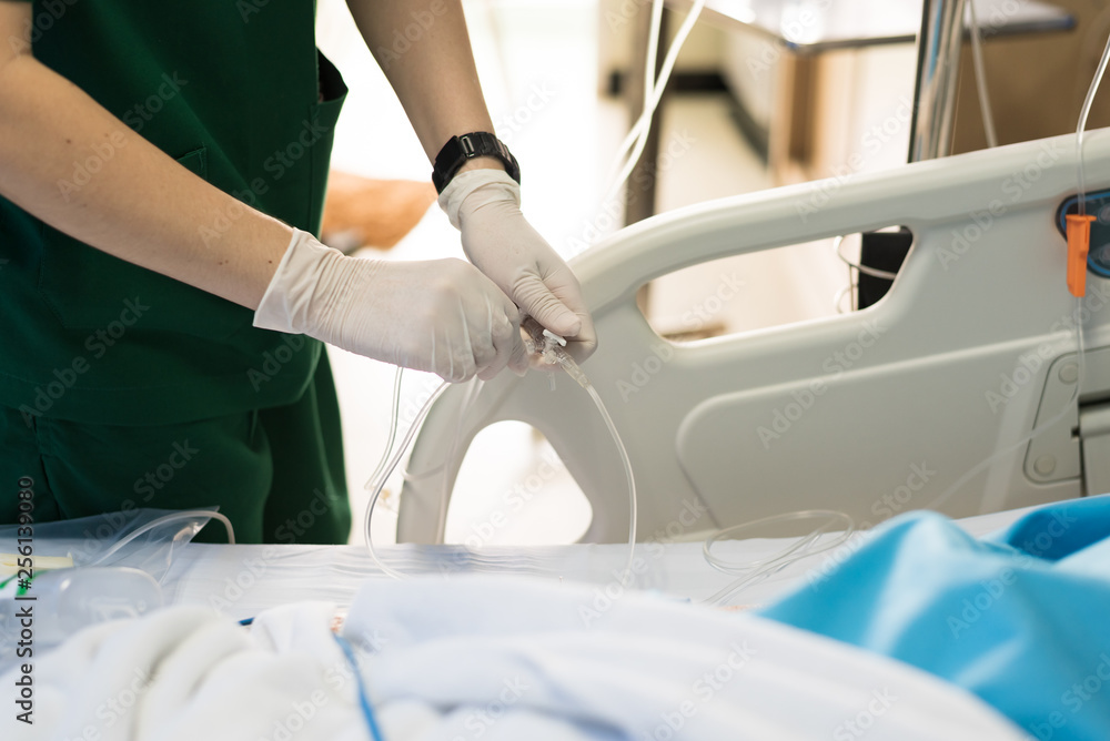 Close up nurse hand adjust three way of iv set fluid intravenous drop ...