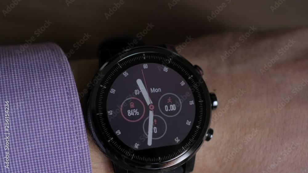 Businessman checks the time on a smartwatch. Close-up. Hands of guy ...