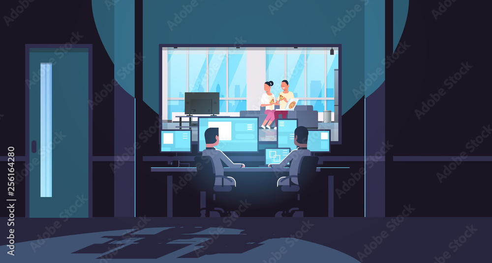 two men looking at monitors behind glass couple eating pizza man woman ...