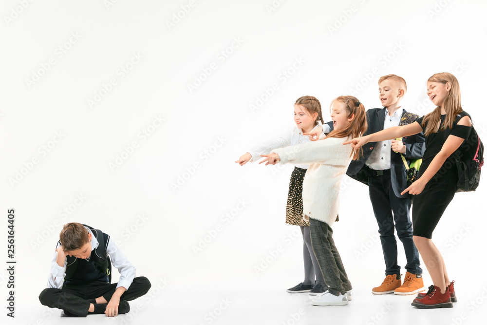 Little boy sitting alone on floor and suffering an act of bullying ...