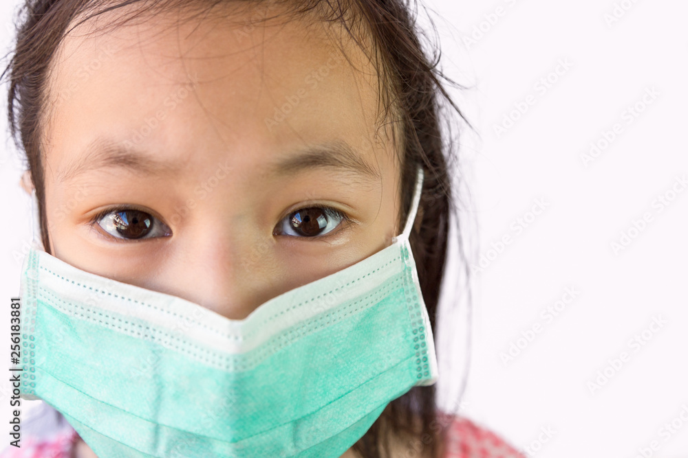Portrait asian little girl in a medical mask isolated on white ...