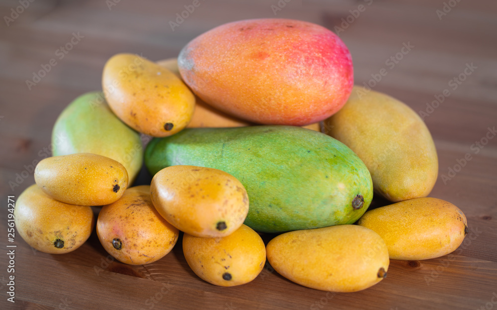 Stack of several varieties of Mangos of different size and colors Stock ...