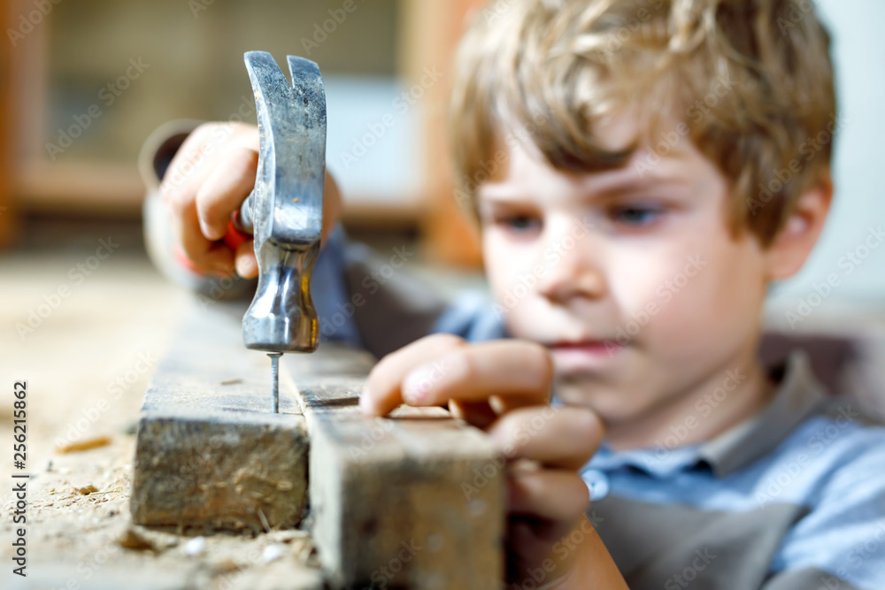 Little kid boy helping with toy tools on construction site. Funny child ...