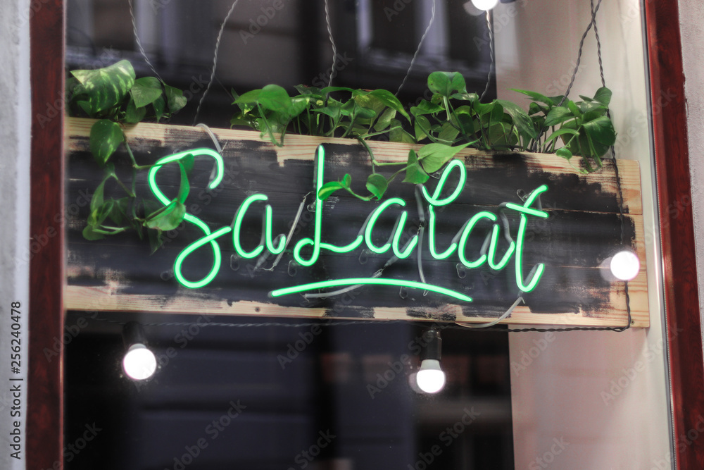 Neon green inscription "SALALAT" store sign Stock Photo | Adobe Stock