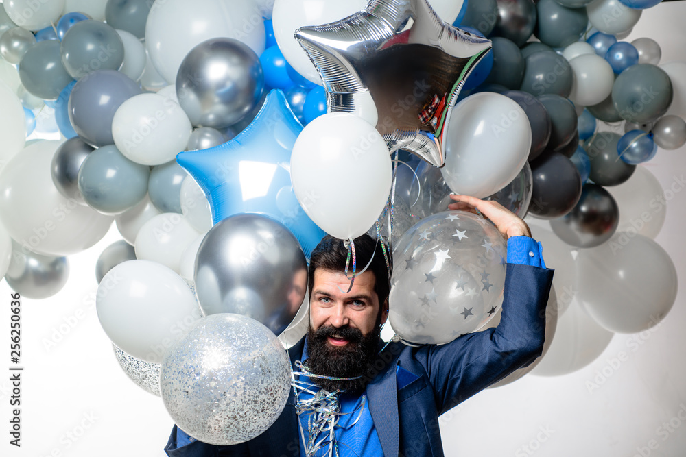 Bearded man with balloons at birthday party. Handsome happy man with ...