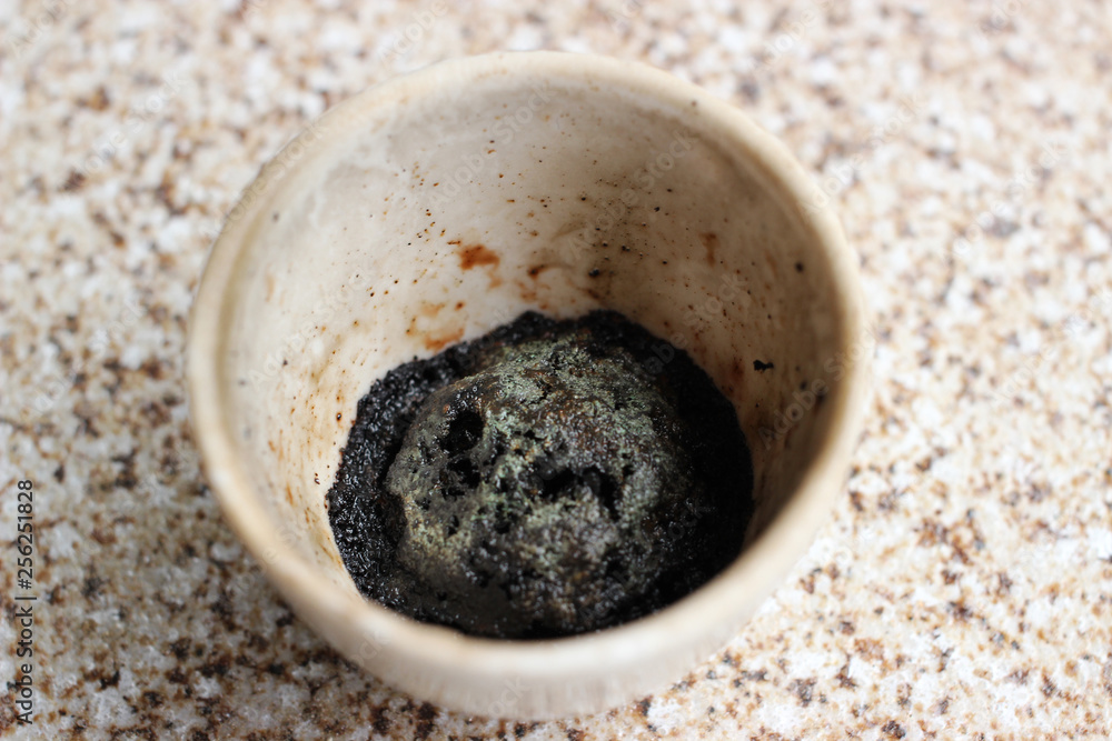 A black precipitate of manganese oxide, which was produced in a ceramic ...