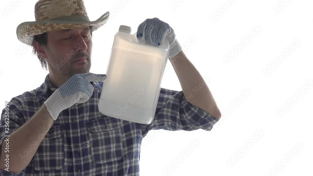 Farmer kissing pesticide jug containing chemical for crop protection ...