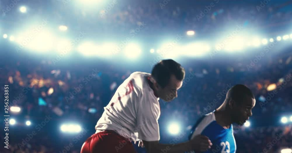 Soccer players fight in mid-air for a ball. The players wear unbranded ...